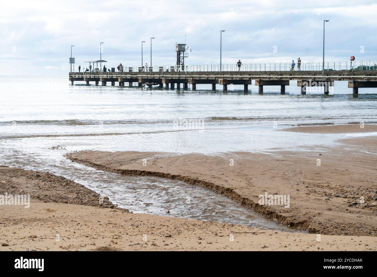 Small creek flowing across sandy beach near Perry Harvey Jetty ...