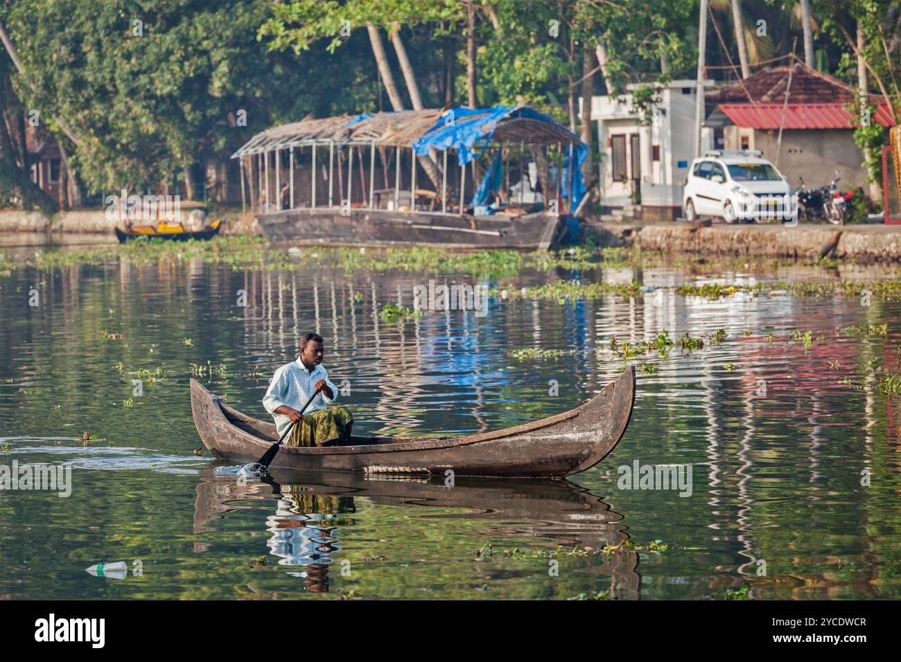indian man in small boat in backwaters Stock Photo - Alamy