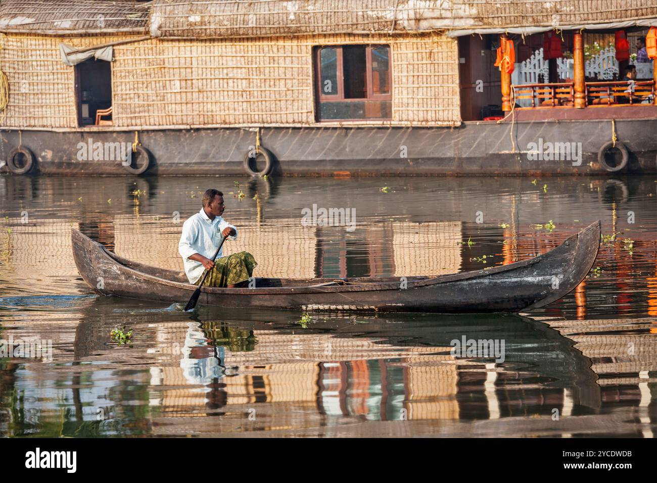 indian man in small boat in backwaters Stock Photo - Alamy