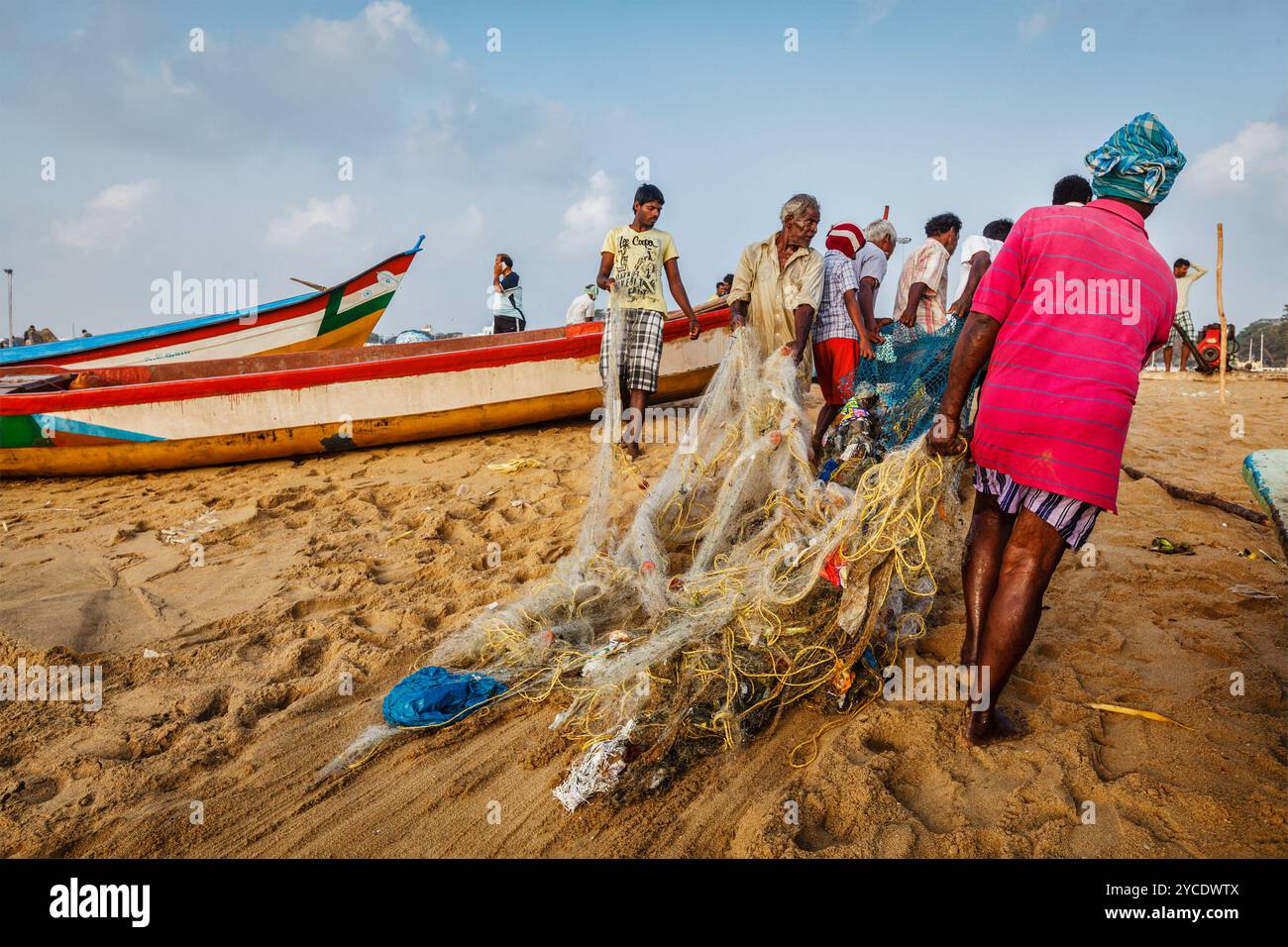 Indian fishermen dragging fishing net with their catch from sea on ...
