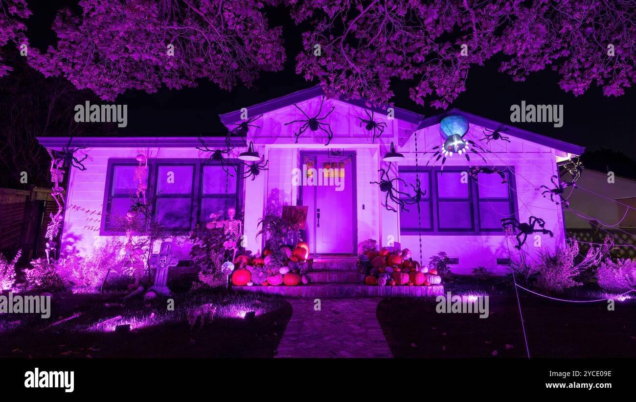 Halloween Themed Haunted House Glowing in the Dark in Pink and Purple ...