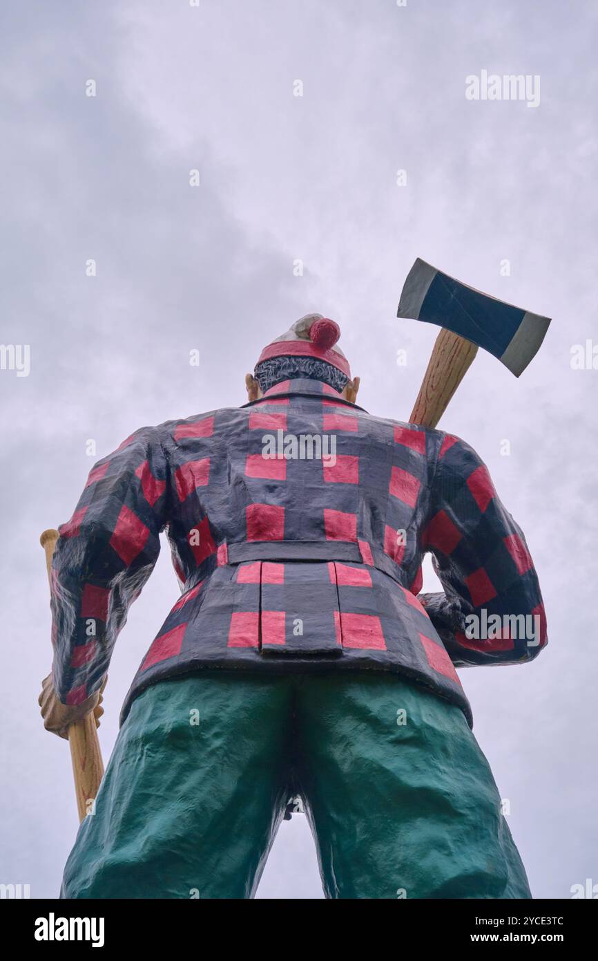 The back, rear of the huge, large, tall Paul Bunyan statue in moody ...