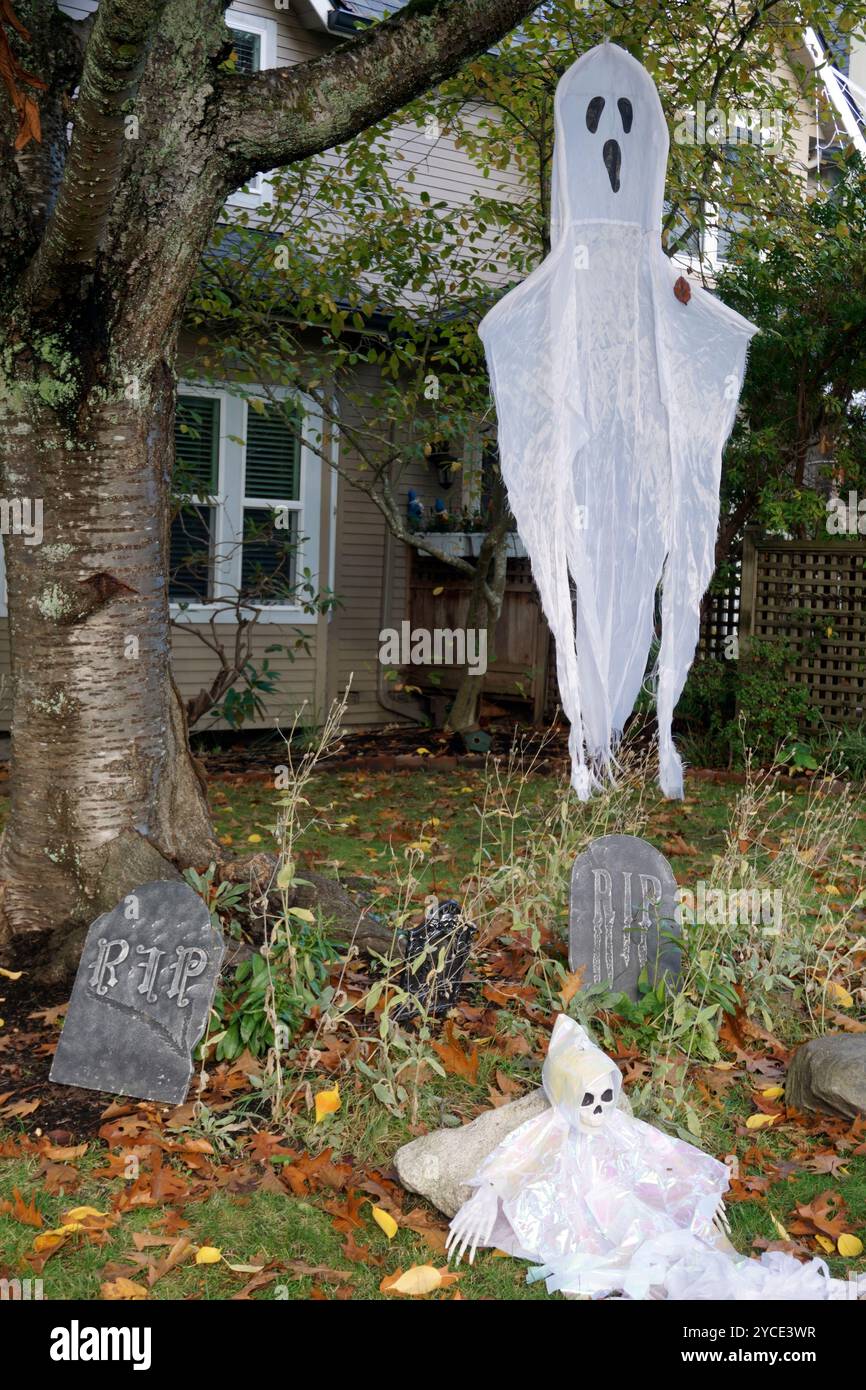 Halloween decorations, white ghosts and tombstones with RIP written on ...