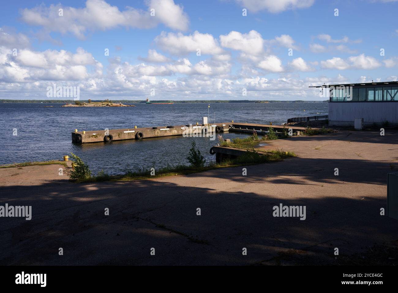 Small seaside industrial building with a dock Stock Photo - Alamy