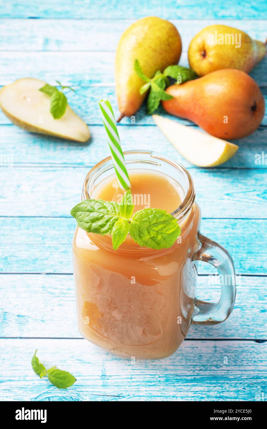 Natural pear juice in a glass cup. Juicy ripe conferences pears and ...