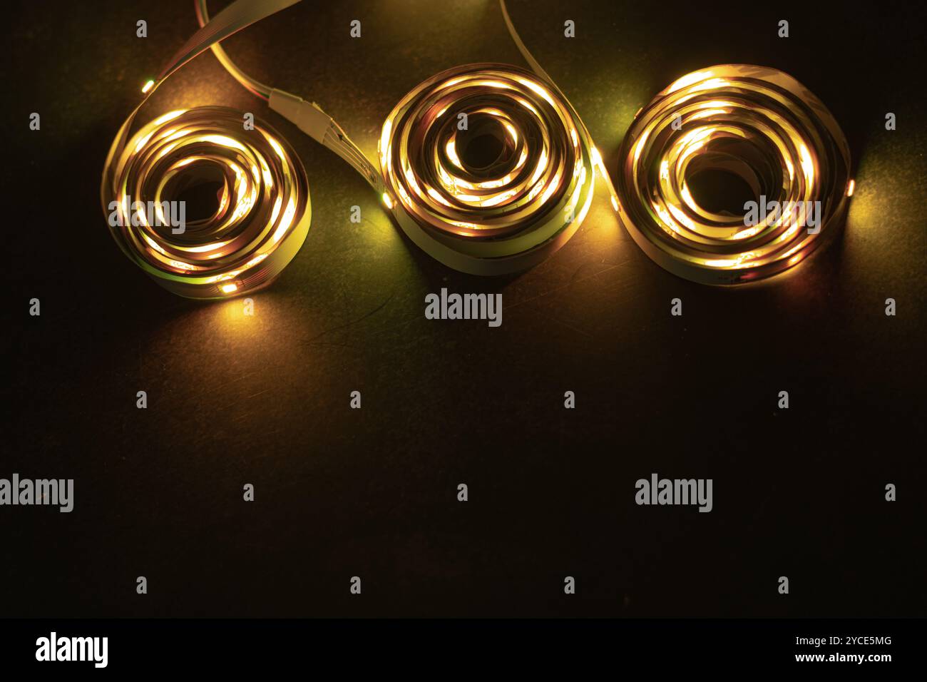 A stack of LED lights on coiled flexible lighting strips, colored ...