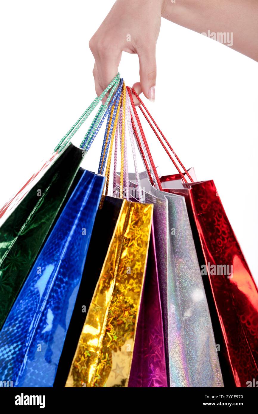 Colorful shopping bags holding by human hand Stock Photo - Alamy