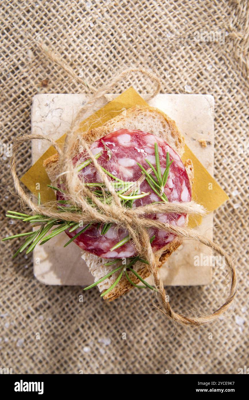 Presentation of a snack of bread and salami Stock Photo - Alamy