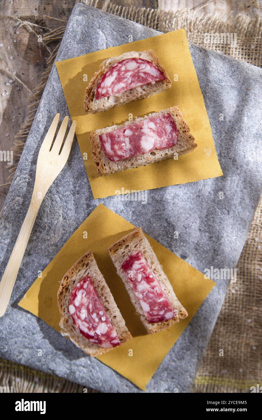 Presentation of a snack of bread and salami Stock Photo - Alamy