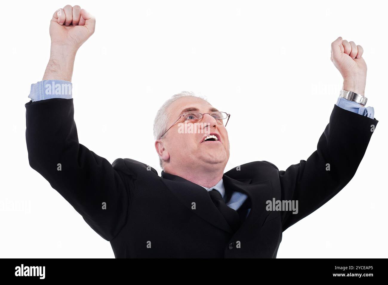 Champion senior business man standing with fists clenched in victory in ...