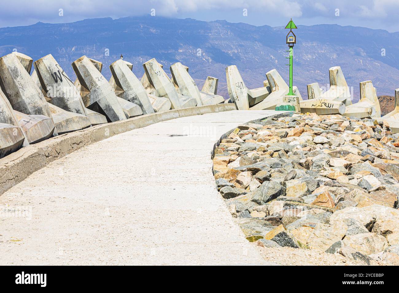 Concrete breakwater with lighthouse in Mirbat harbour, Dhofar province ...