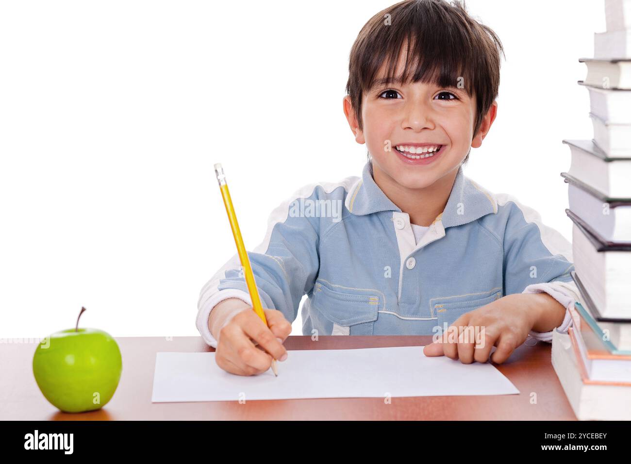 School boy doing his homework with an apple beside him Stock Photo - Alamy