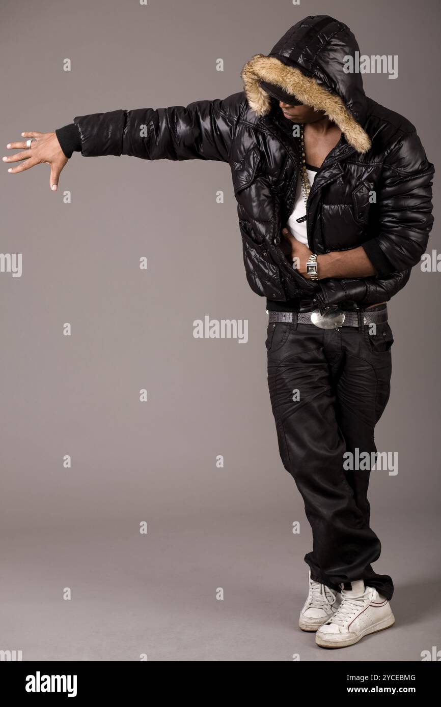Black african rap performer on grey background Stock Photo - Alamy
