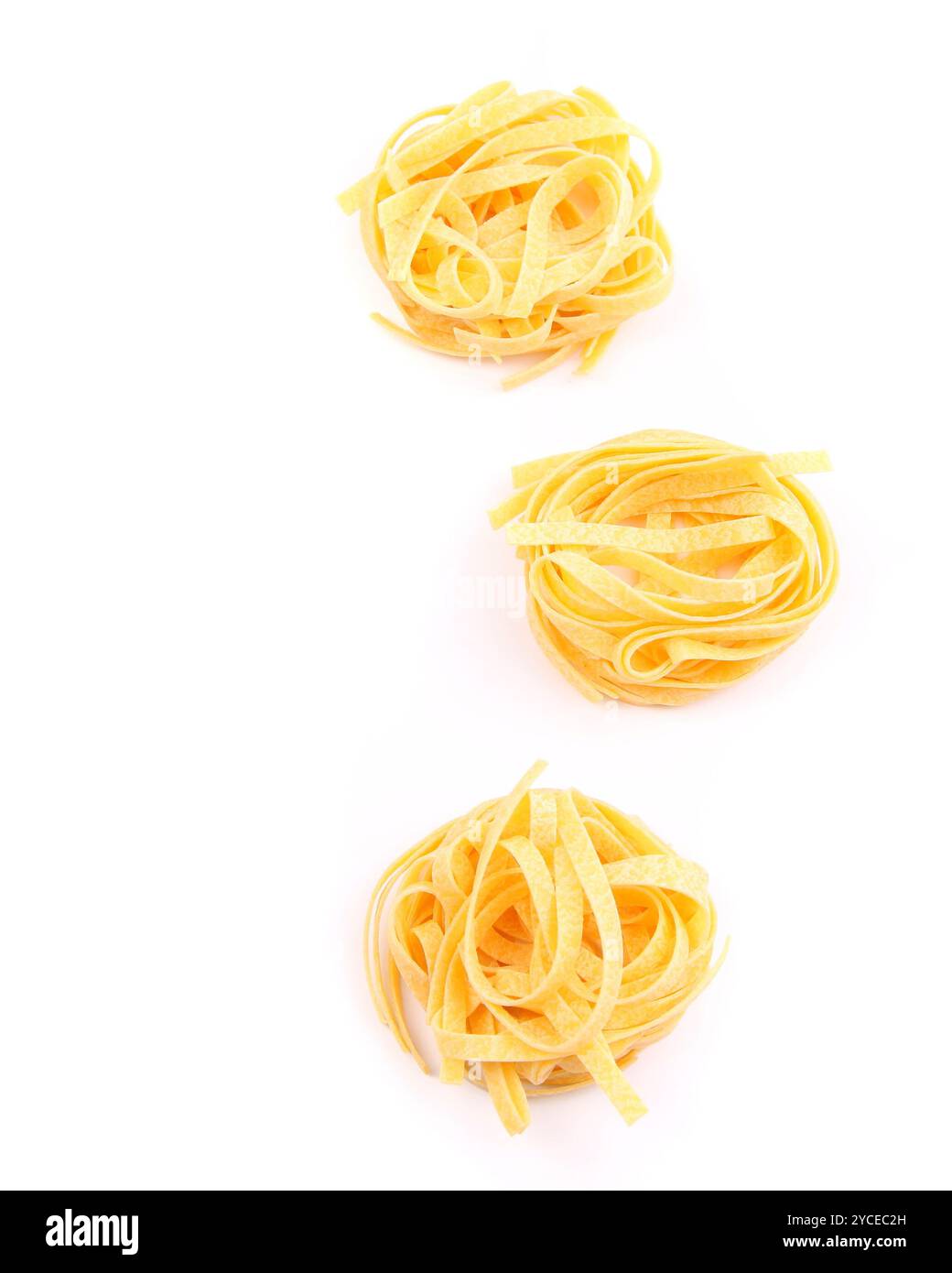 Three fettuccini pasta nests isolated on white Stock Photo - Alamy