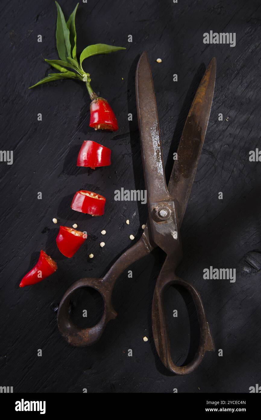 Cut the chili pepper with the use of scissors Stock Photo - Alamy