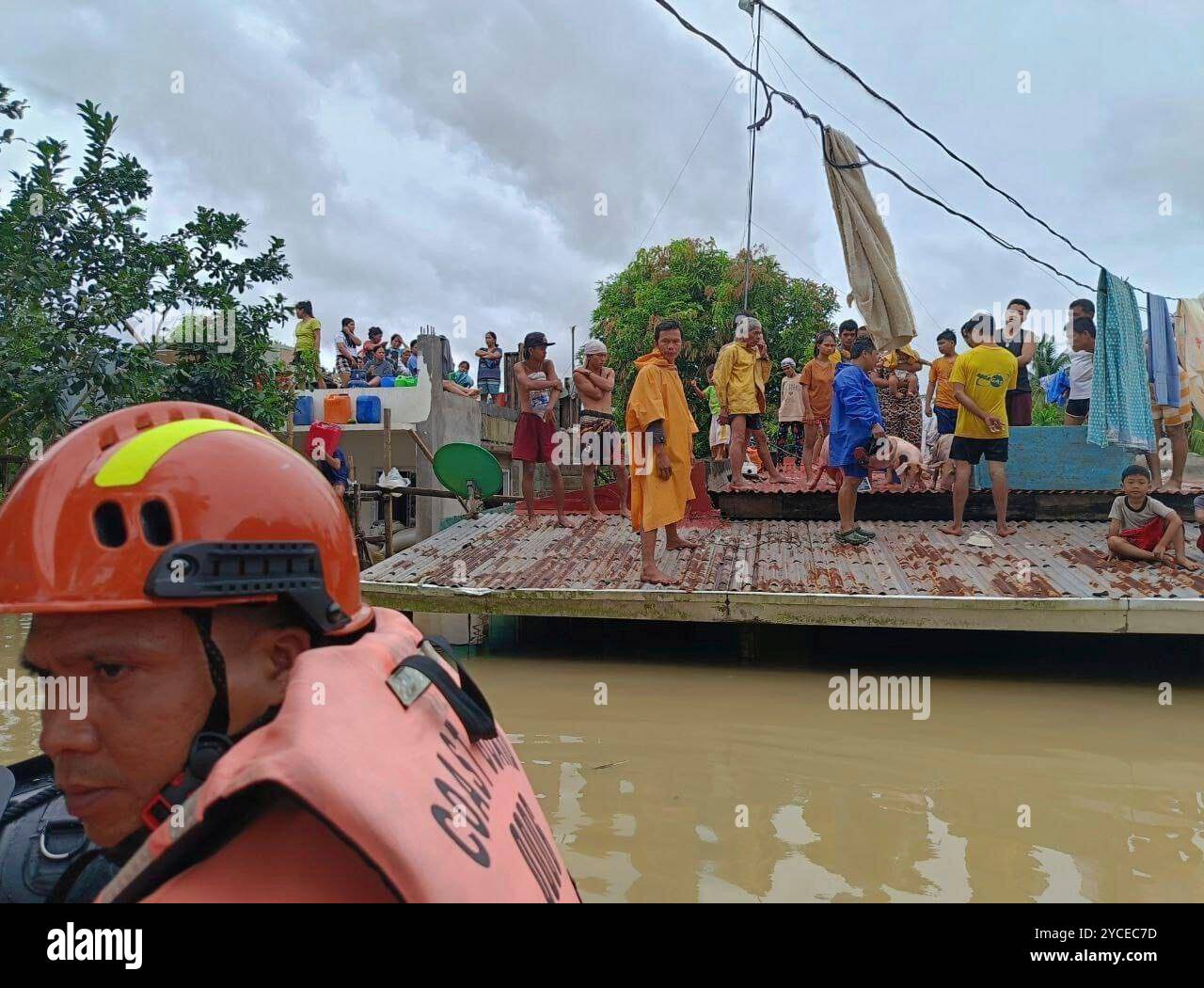 In this photo provided by the Philippine Coast Guard, residents wait on ...