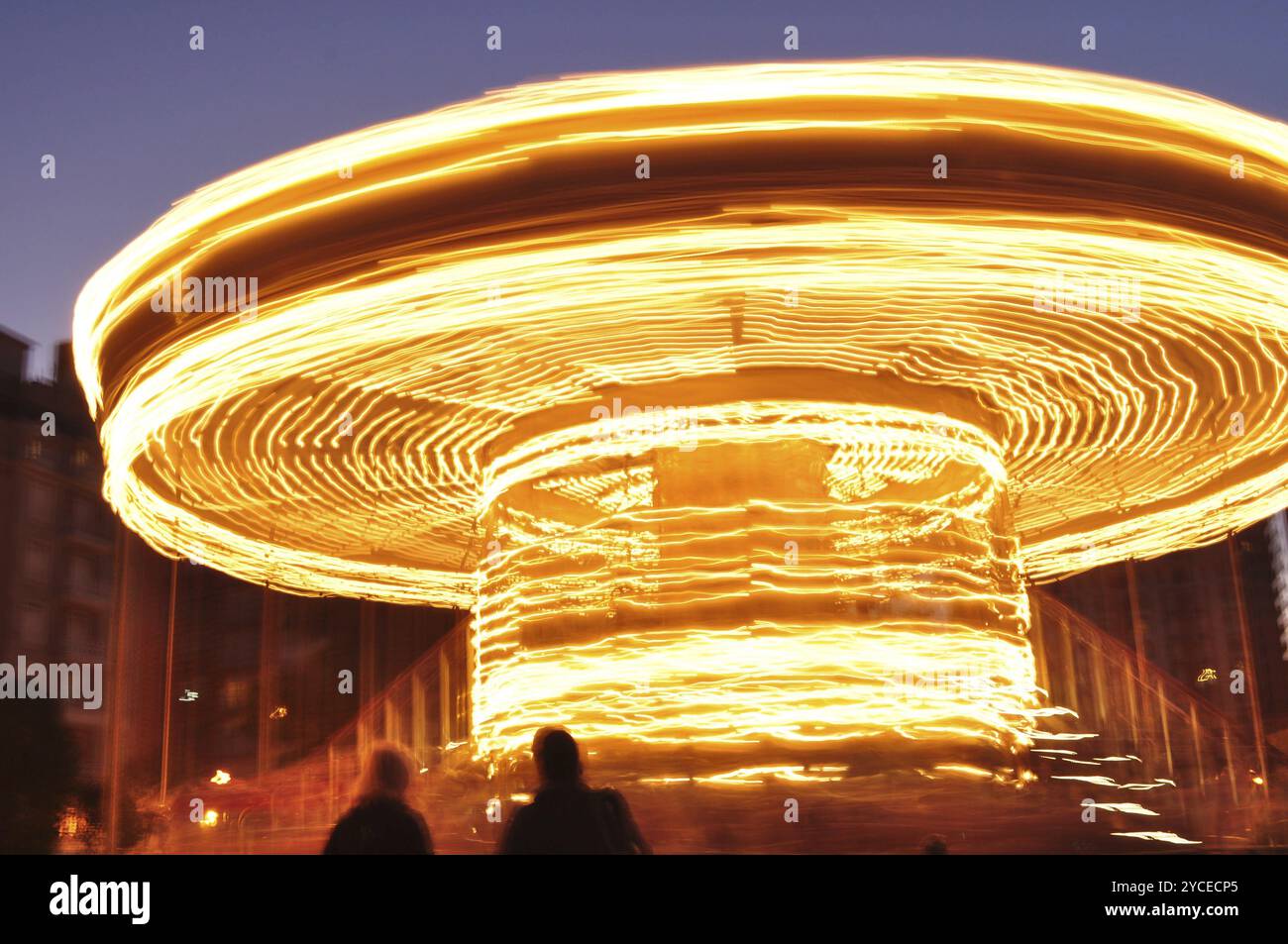 Lighted Carousel spinning at night Stock Photo - Alamy