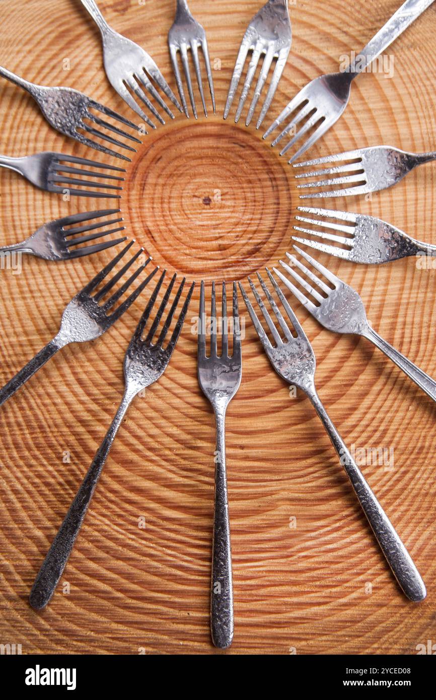 Series of different forks in a circle of pine board Stock Photo - Alamy