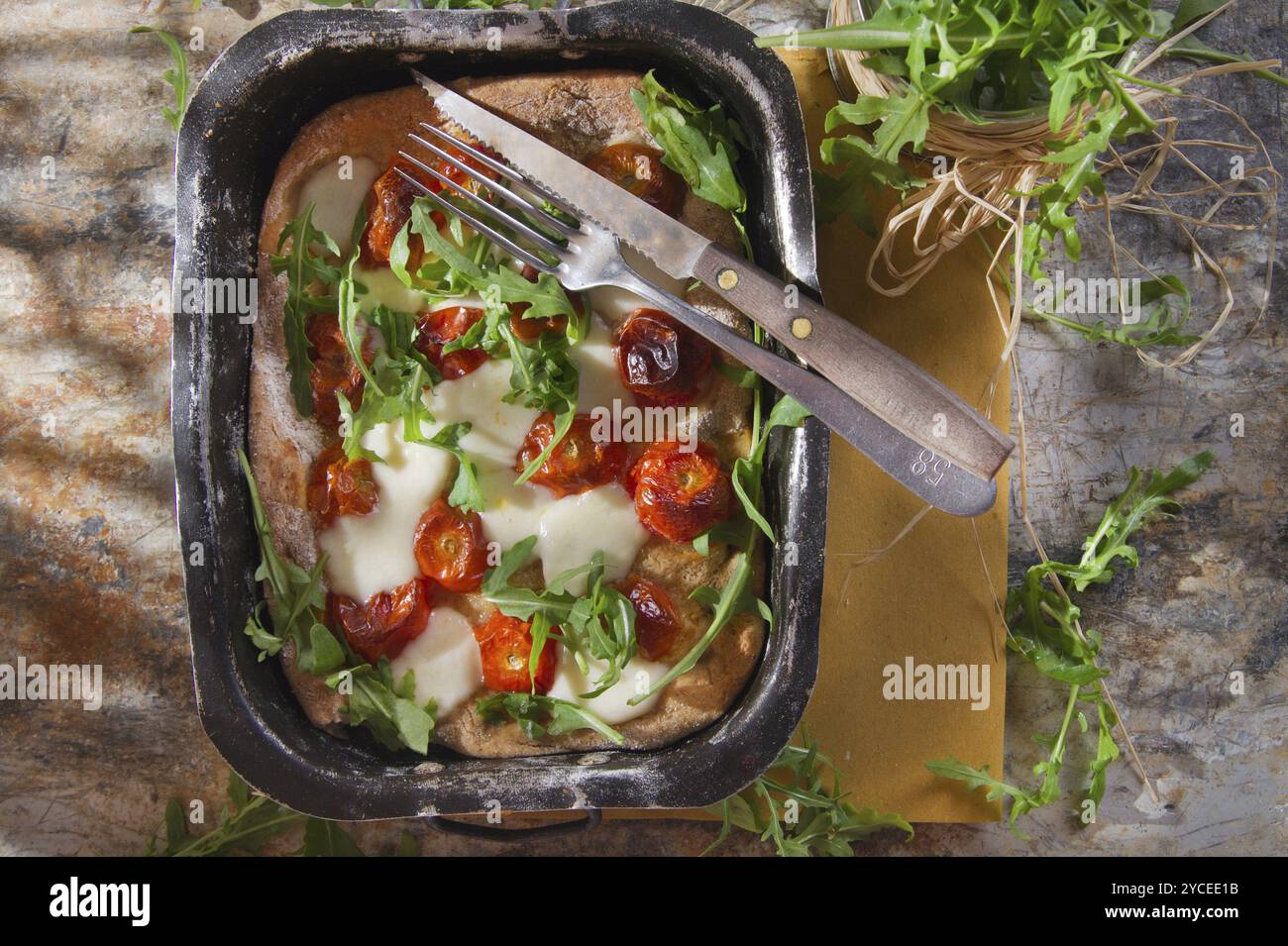 Tricolor pizza with tomato mozzarella and fresh arugula Stock Photo - Alamy