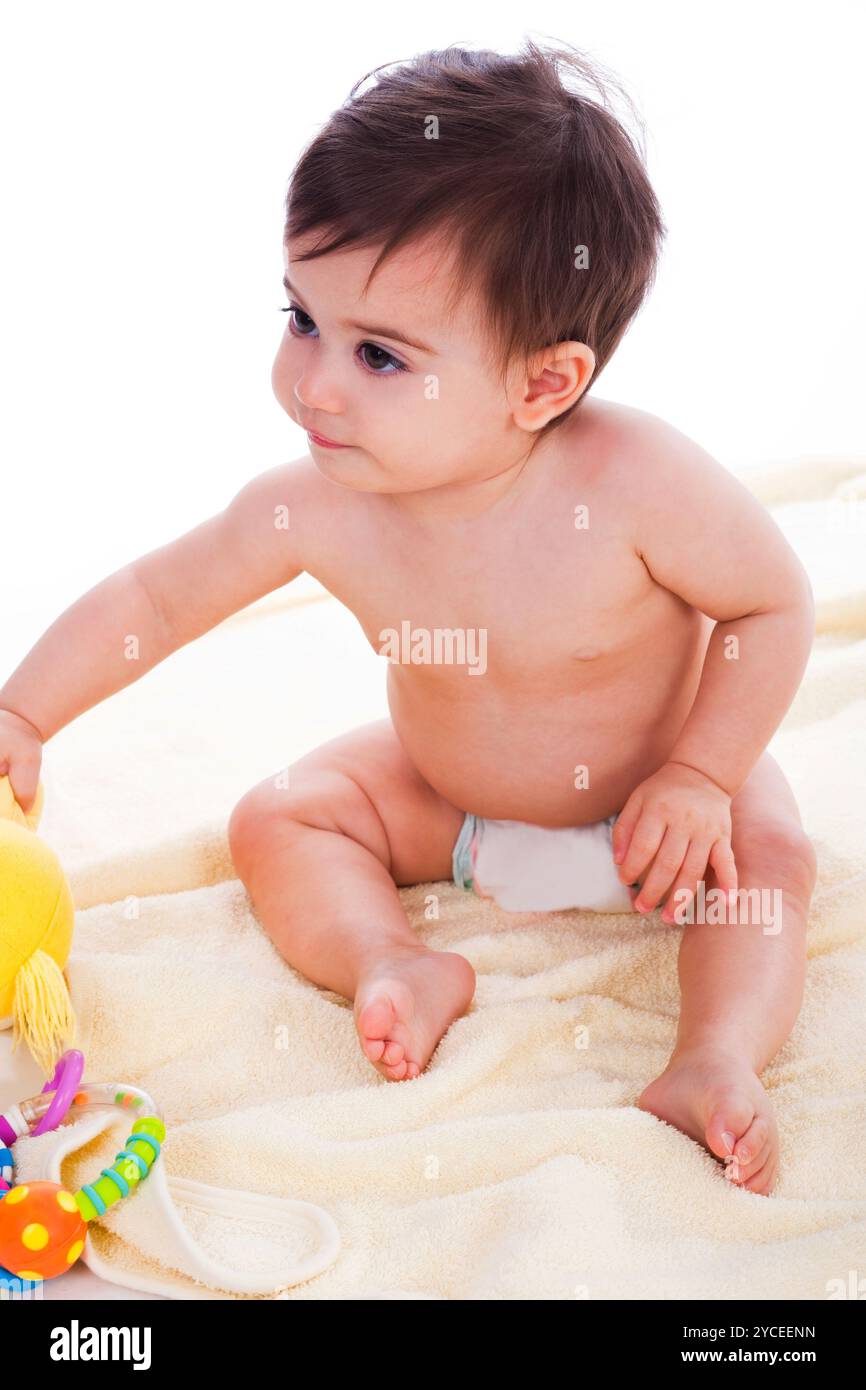 Toddler sitting with toys Stock Photo - Alamy