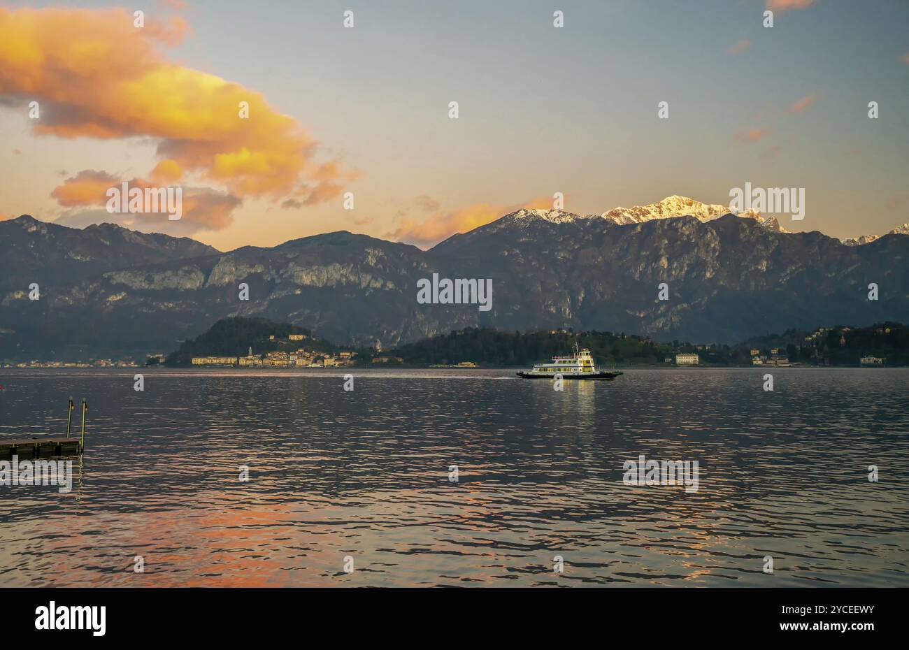 Amazing scene with pink sky. Lake Como and a ship picking up passengers ...