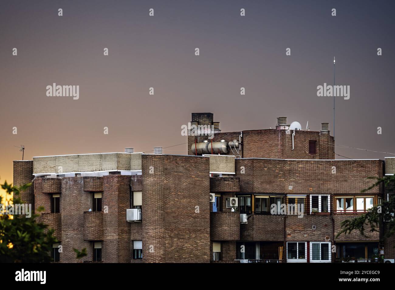 Residential brick building in the city against dark cloudy sky. Real ...