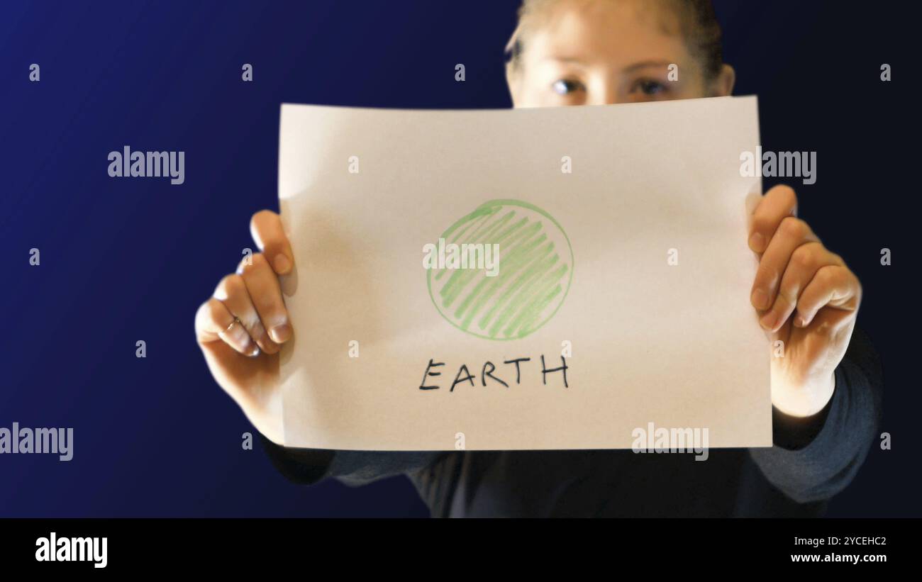 Teenage girl, holding a sheet of paper with a drawing representing the ...
