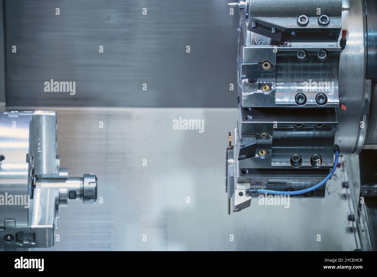 The CNC lathe machine forming cutting the metal parts. hi-technology ...