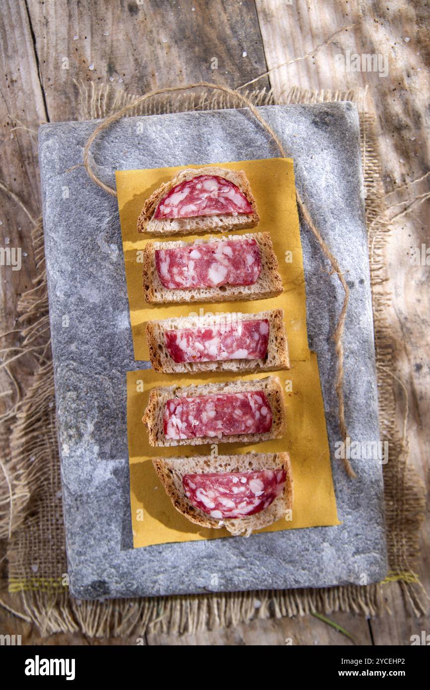 Presentation of a snack of bread and salami Stock Photo - Alamy