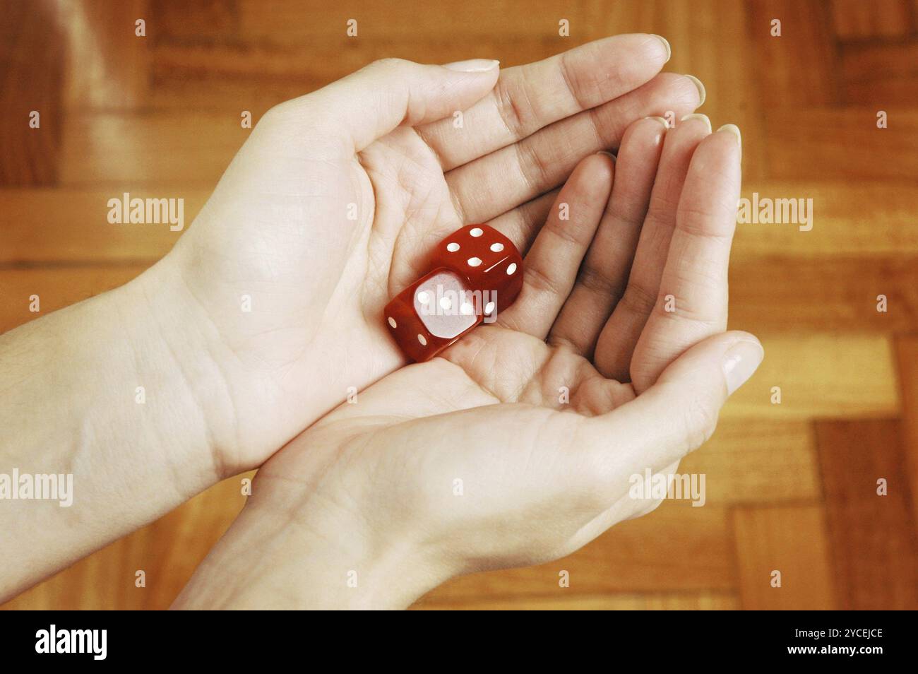 Female Hands holding two red Dice Stock Photo - Alamy