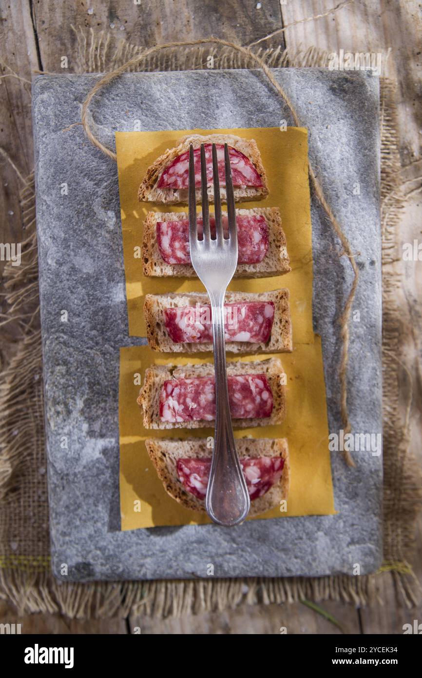 Presentation of a snack of bread and salami Stock Photo - Alamy