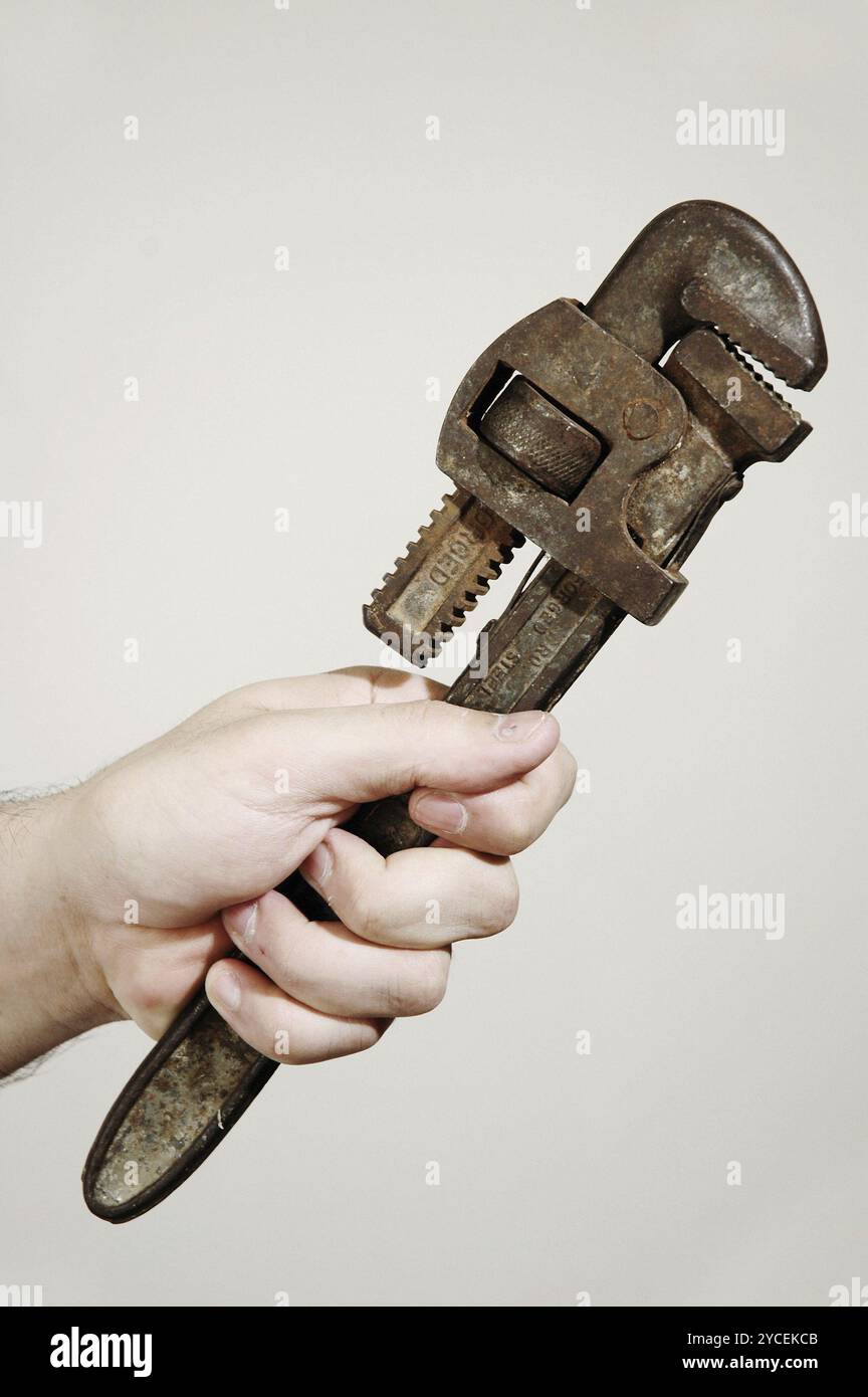 Hand with Spanner on white background Stock Photo - Alamy
