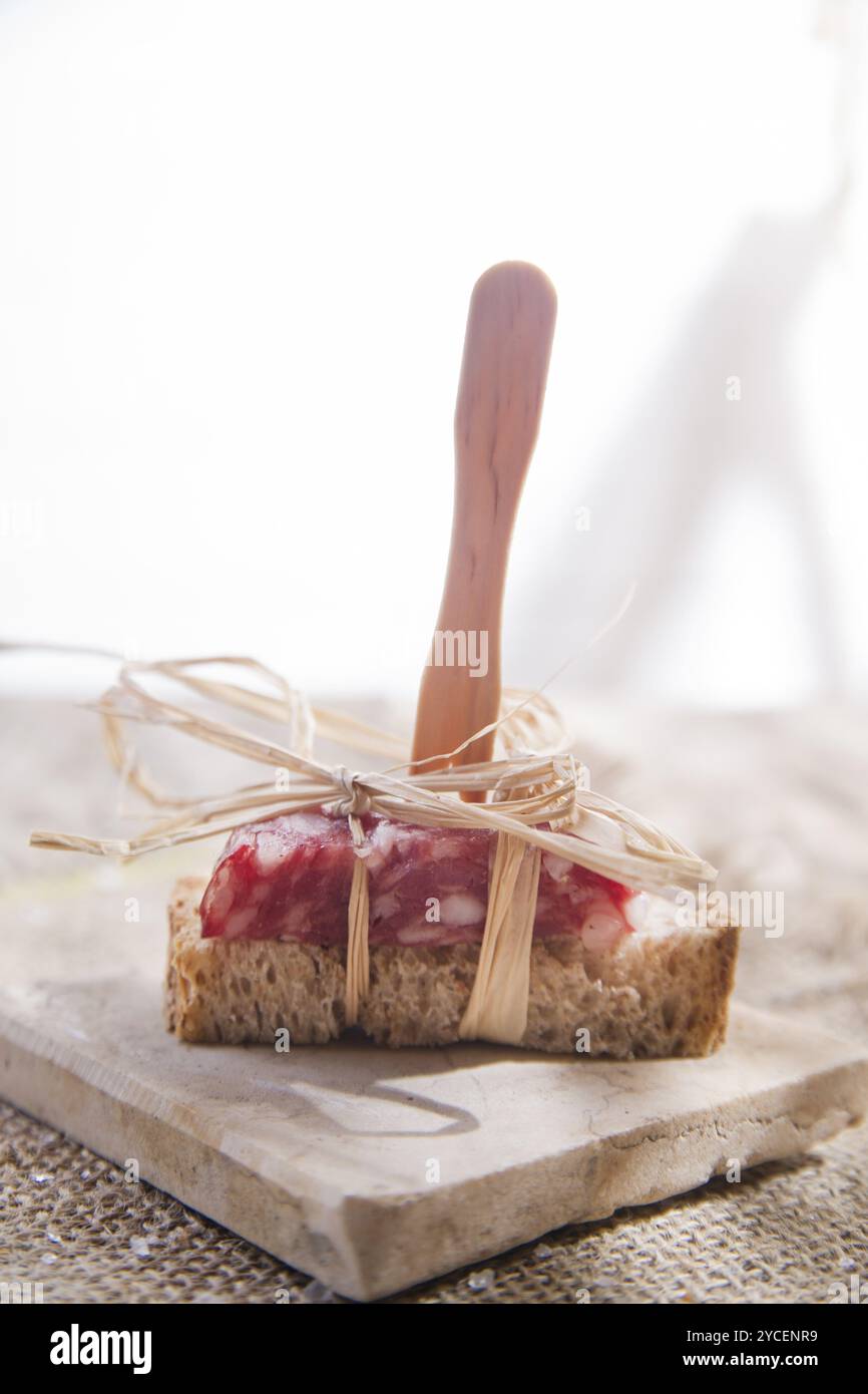 Presentation of a snack of bread and salami Stock Photo - Alamy