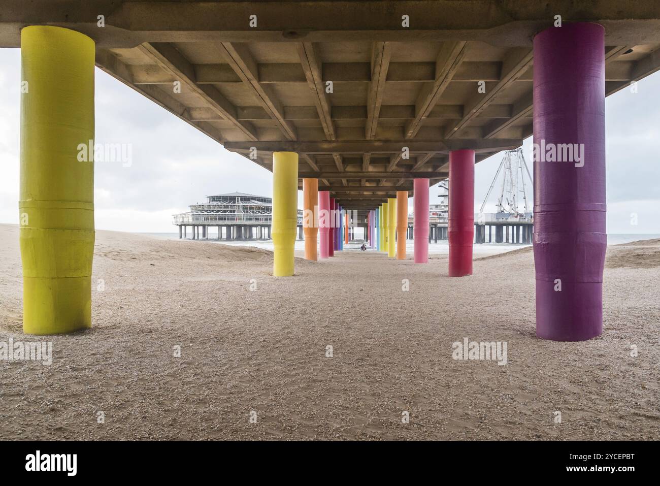 Shot under pier with color painted columns on the beach at sunset Stock ...