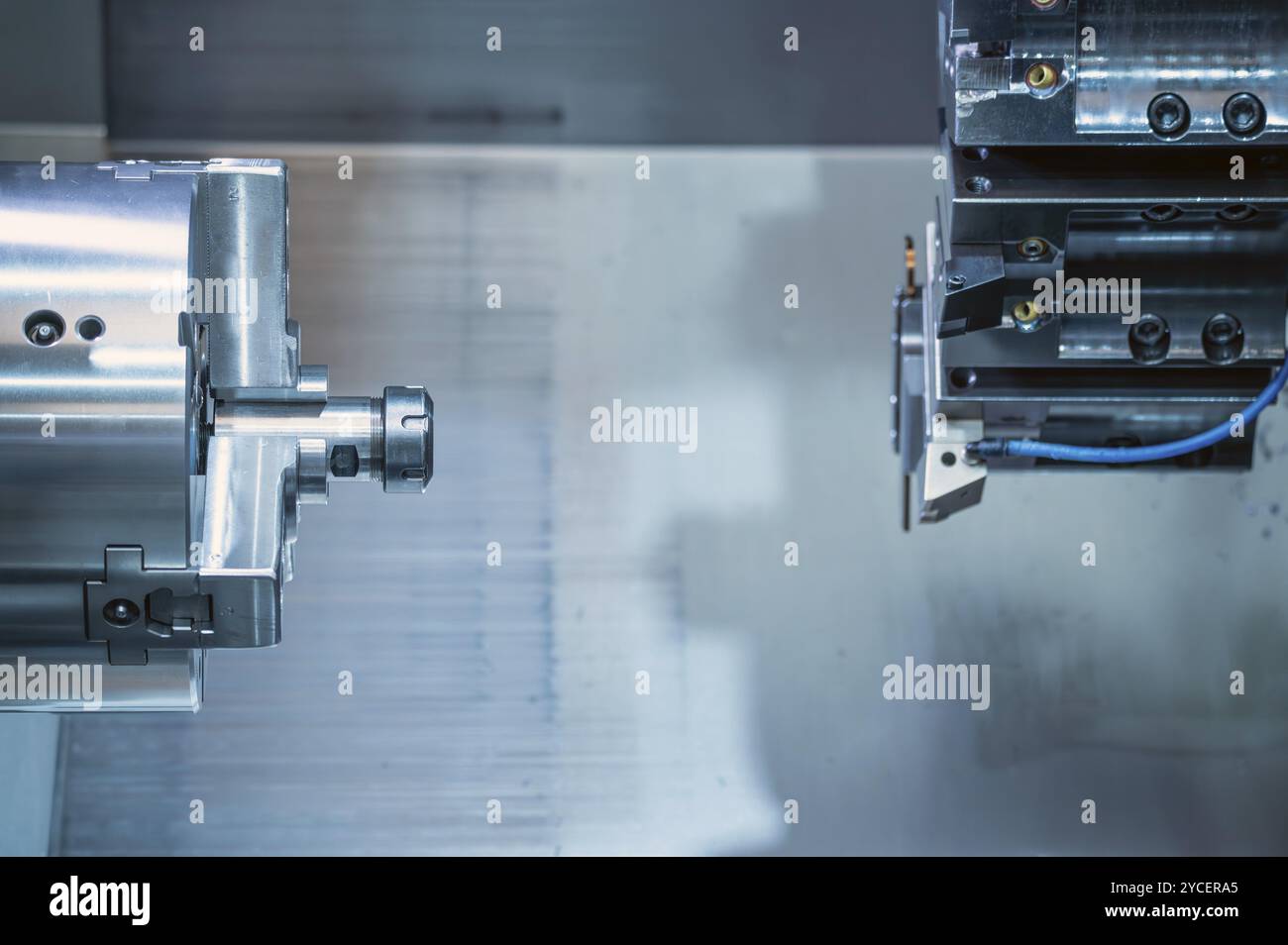 The CNC lathe machine forming cutting the metal parts. hi-technology ...