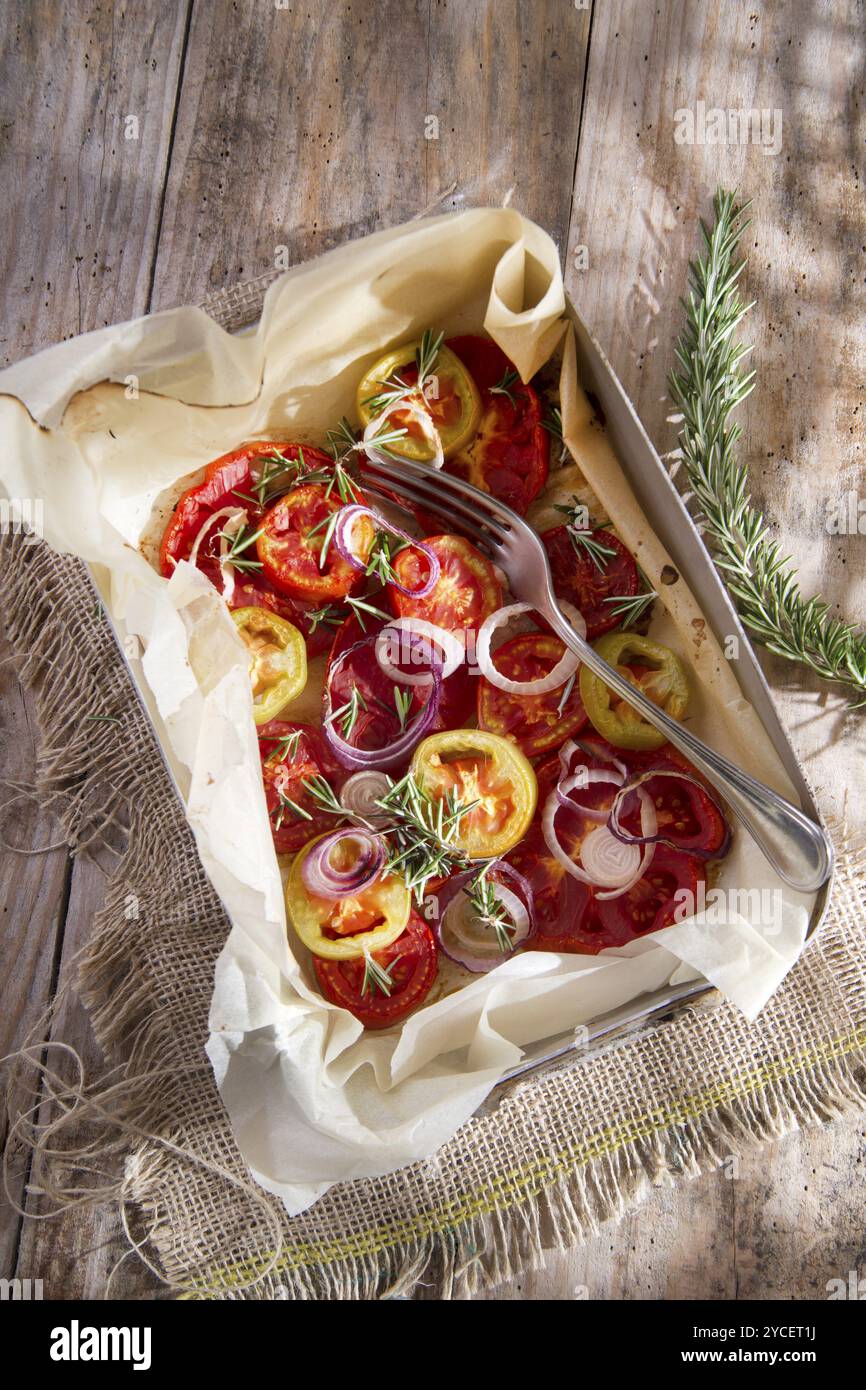 Presentation of a contour-based tomato slices baked with onions Stock ...