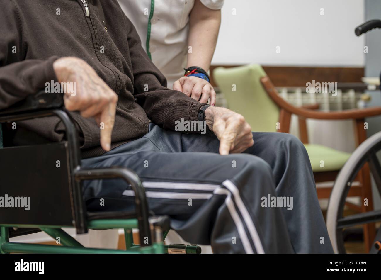 Caregiver assisting elderly man in dining room at nursing home. graphy ...