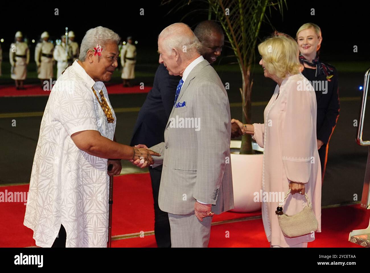 King Charles III is greeted by Samoa's Prime Minister Fiame Naomi Mata'afa and Queen Camilla is ...