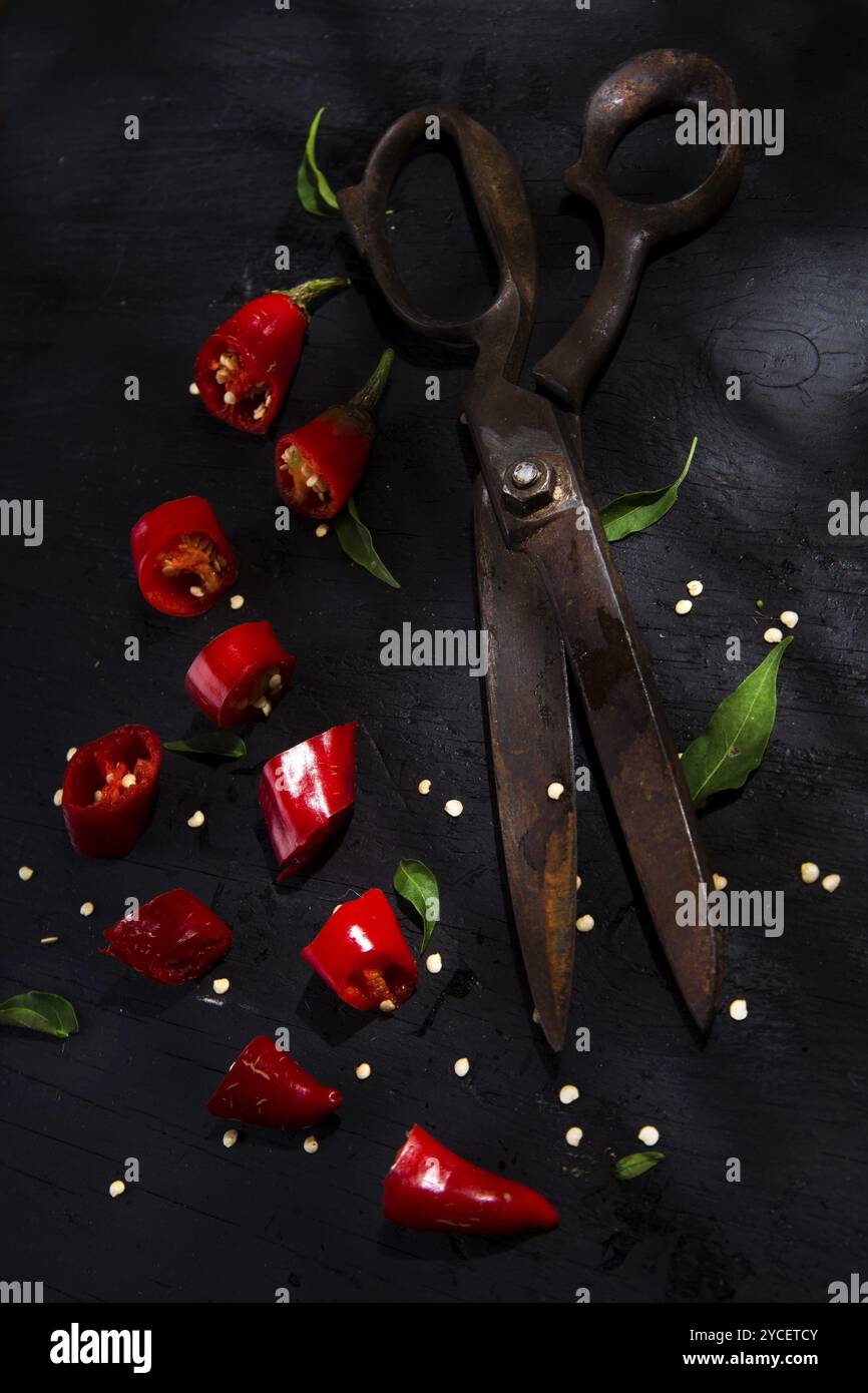 Cut the chili pepper with the use of scissors Stock Photo - Alamy