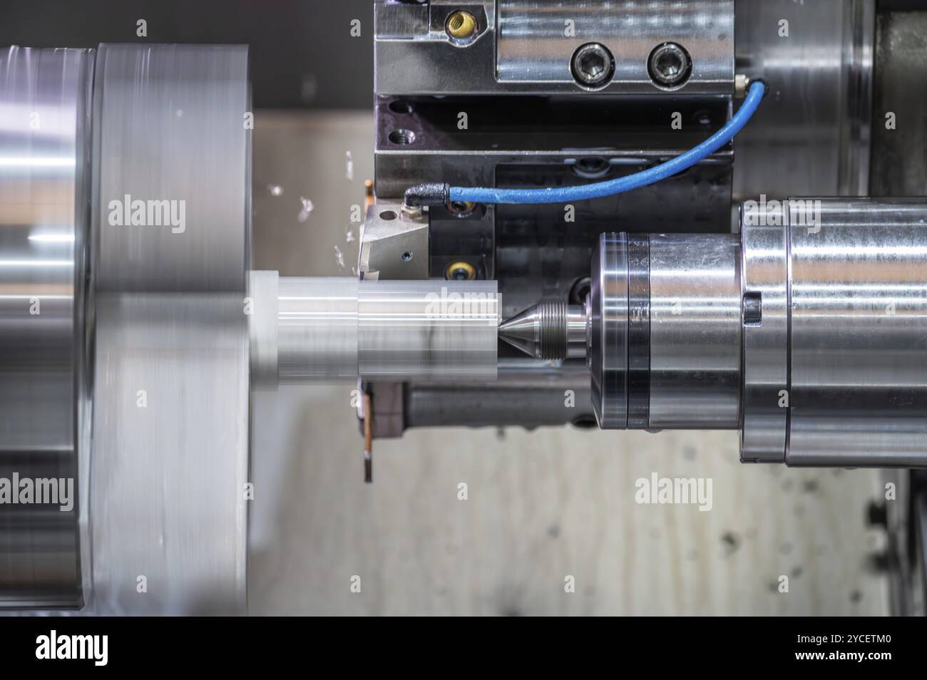 The CNC lathe machine forming cutting the metal parts. hi-technology ...