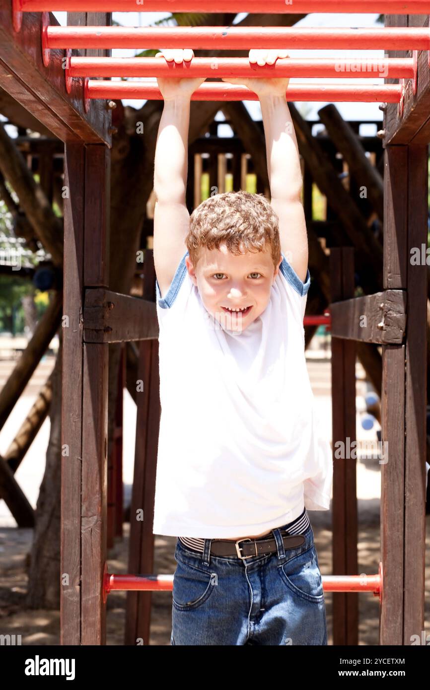 Boy playing outdoors Stock Photo - Alamy