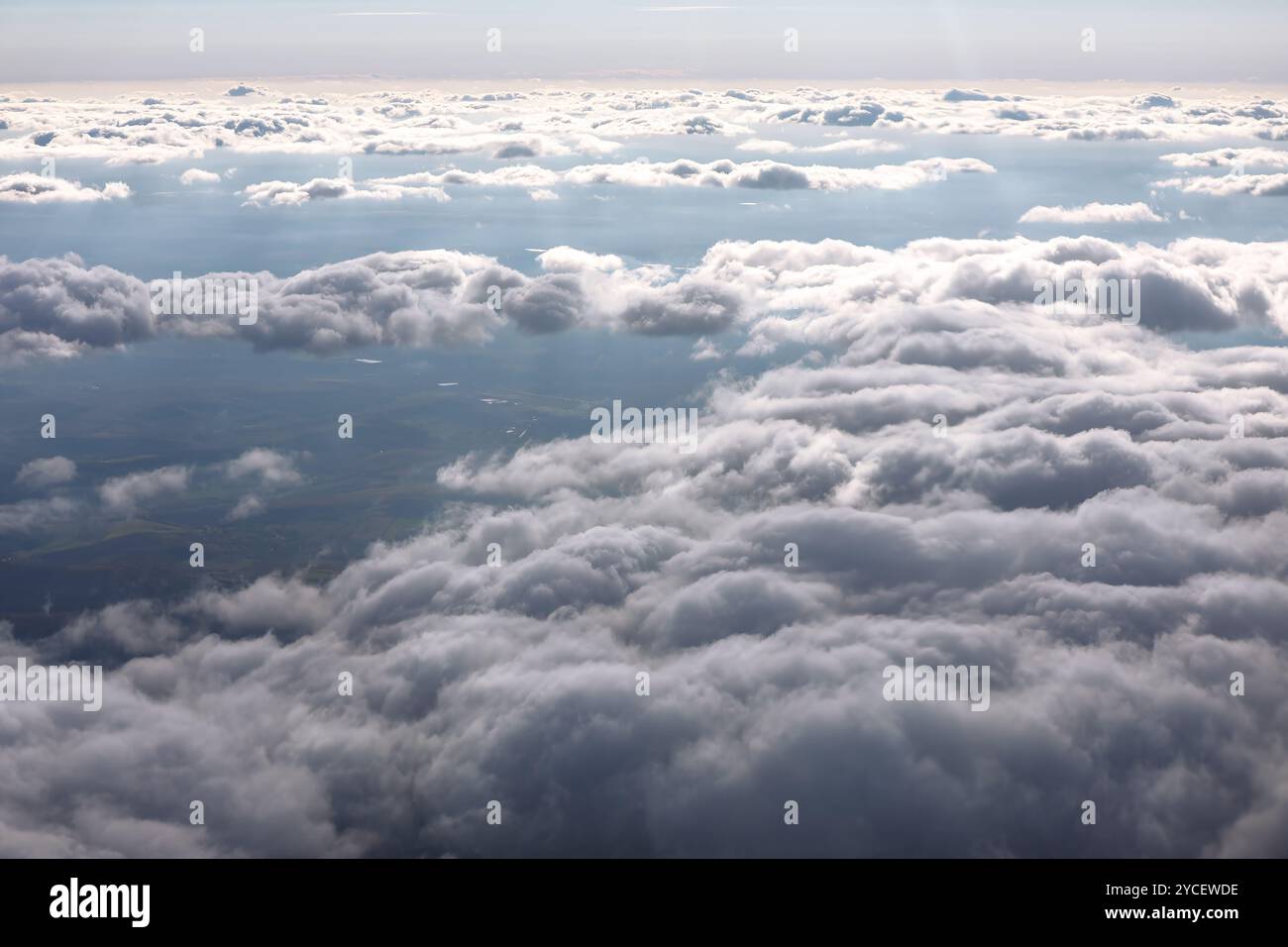Expansive sky filled with soft clouds, captured from the perspective of ...