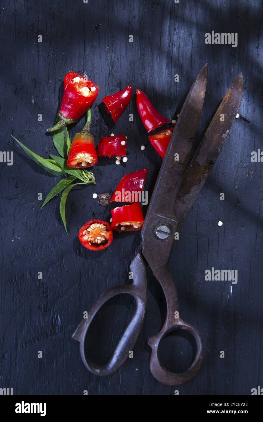 Cut the chili pepper with the use of scissors Stock Photo - Alamy