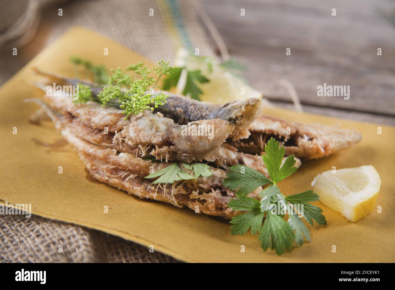 Presentation of a seafood platter, fried anchovies Stock Photo - Alamy