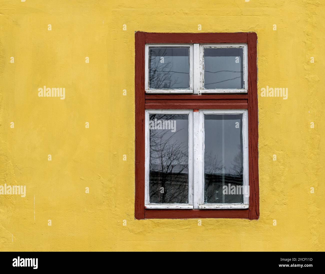 Old red window frame on a yellow wall Stock Photo - Alamy