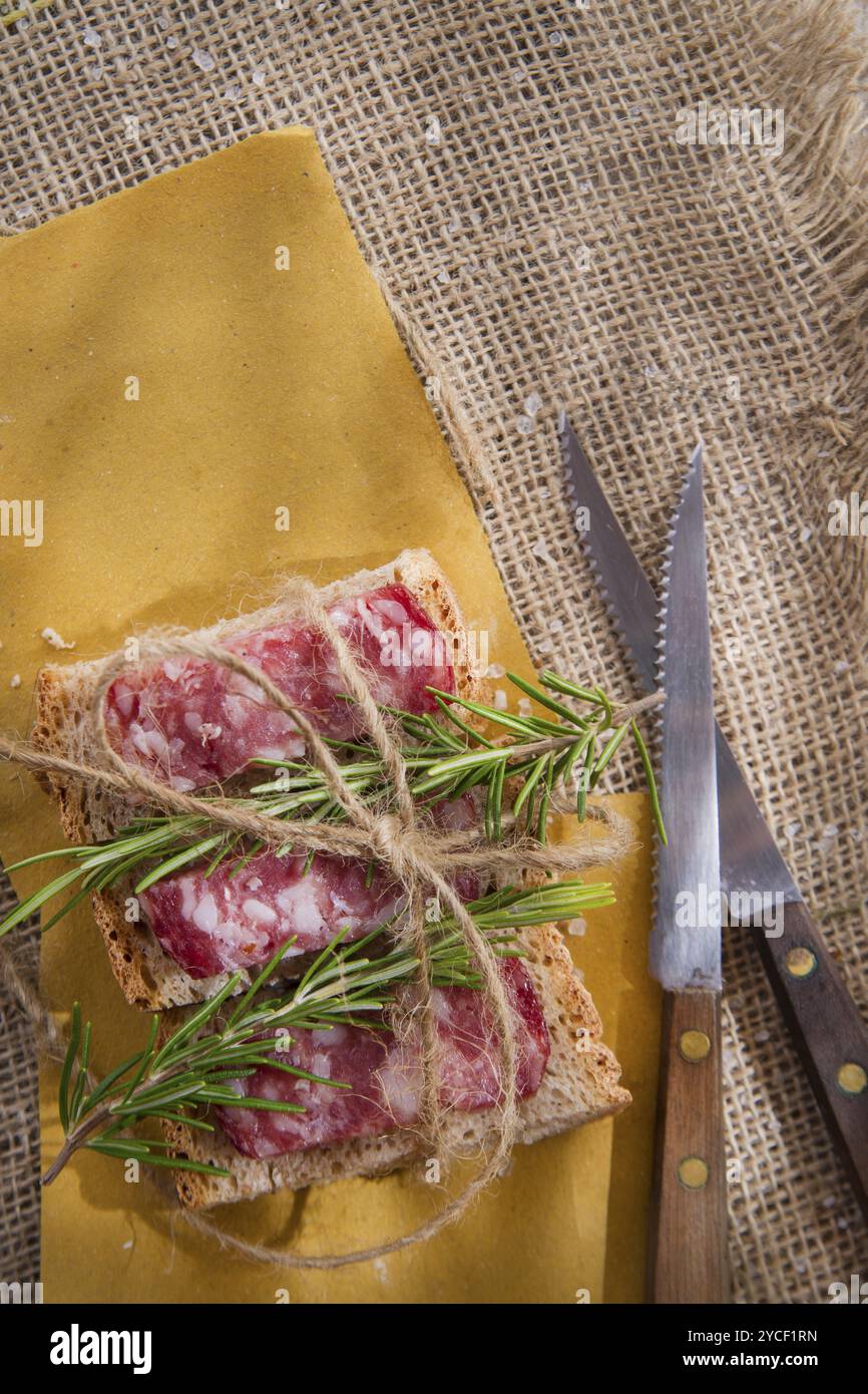 Presentation of a snack of bread and salami Stock Photo - Alamy
