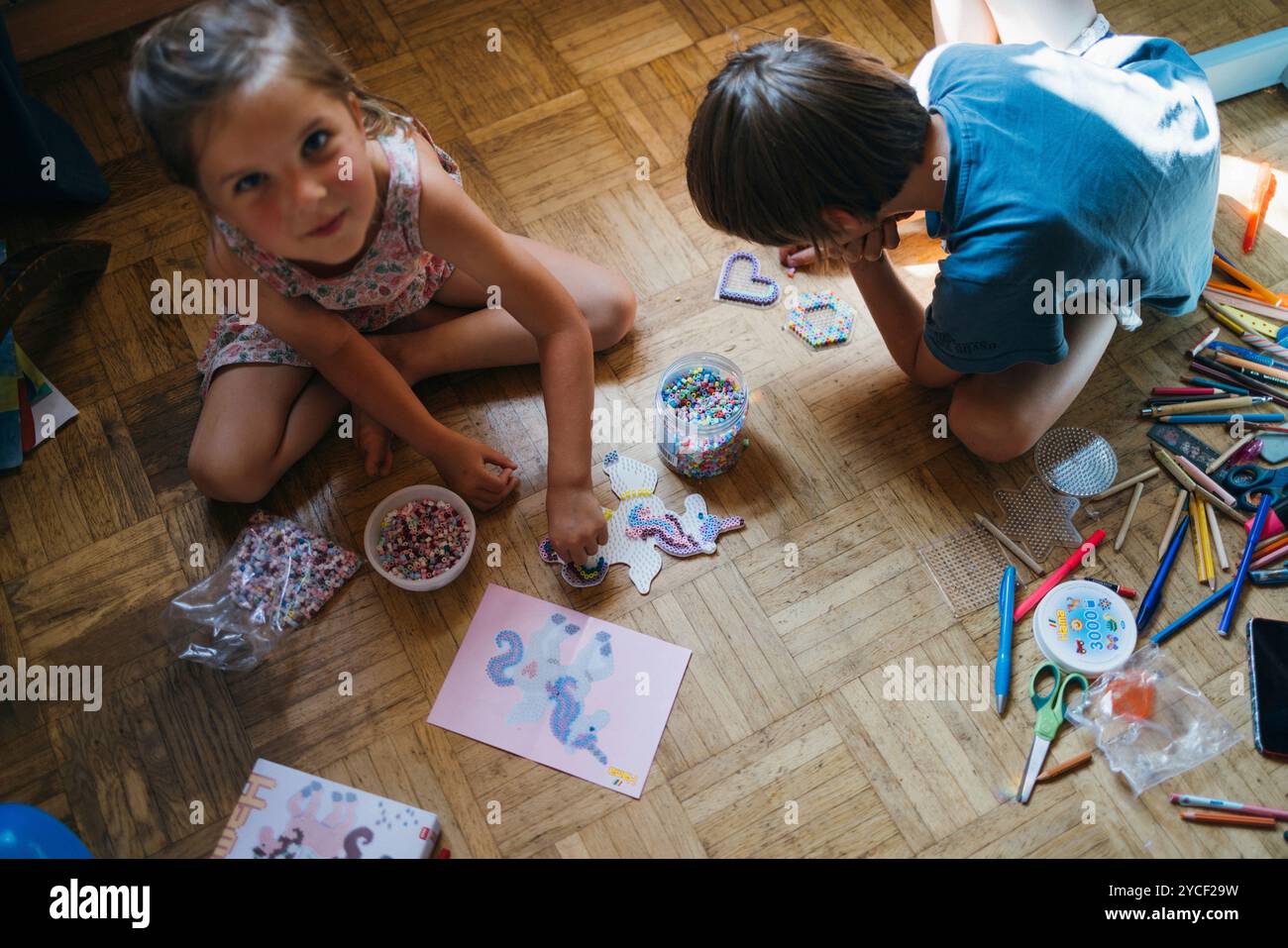 Children doing handicrafts with iron-on beads Stock Photo - Alamy