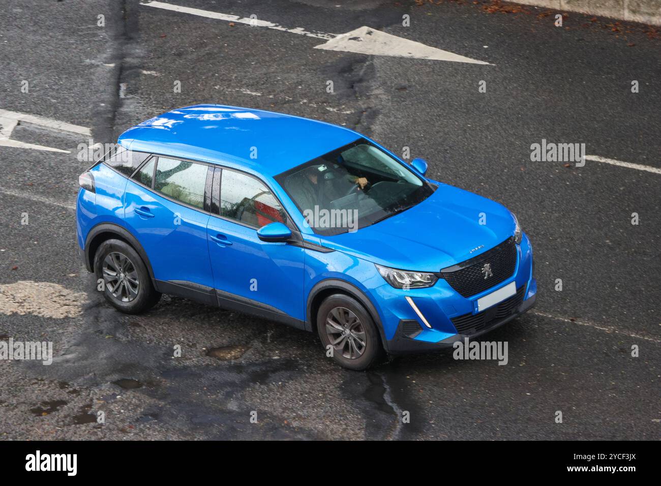 Blue peugeot 2008 suv driving on an asphalt road Stock Photo - Alamy