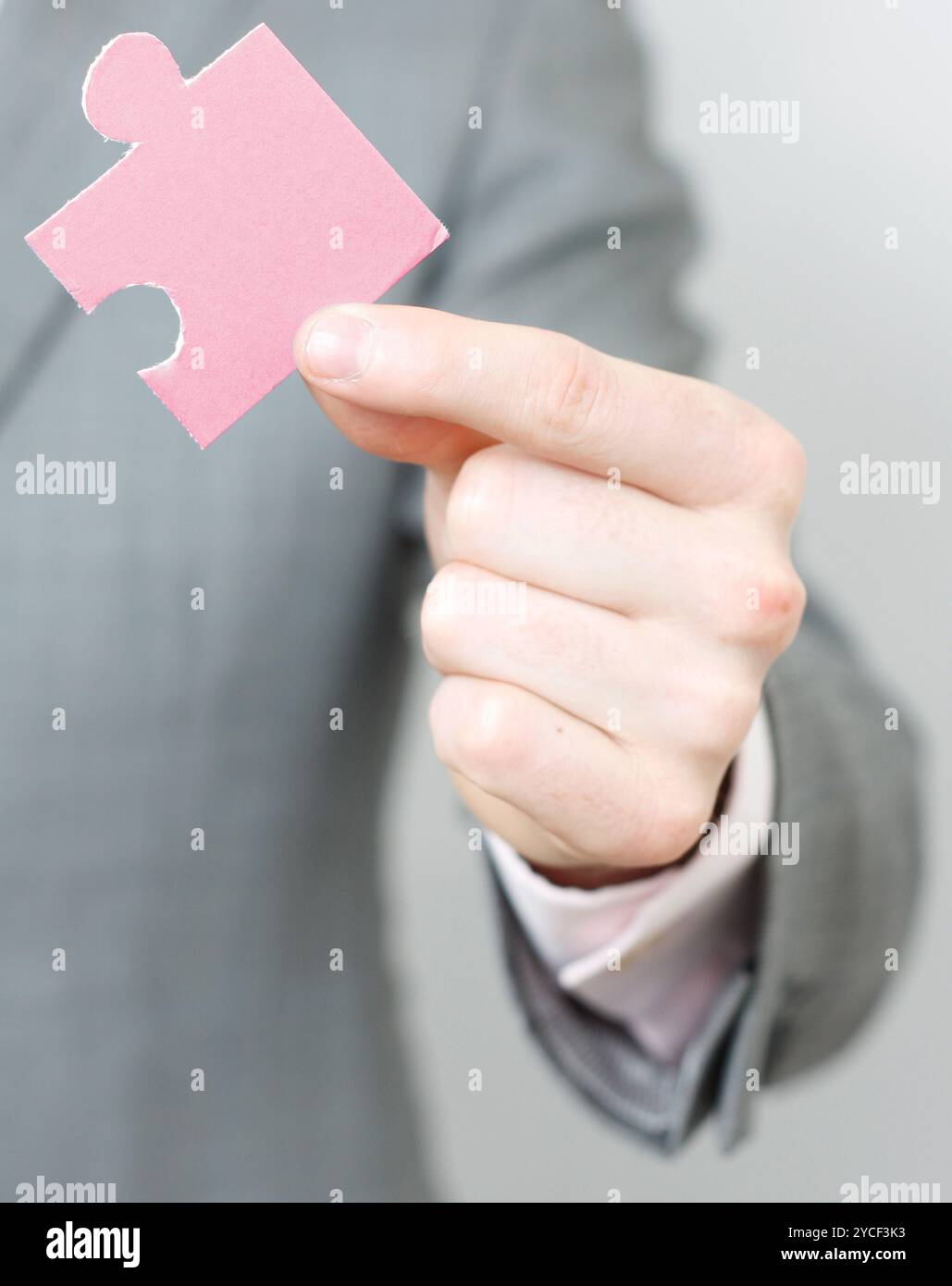 A business man solving a puzzle Stock Photo - Alamy