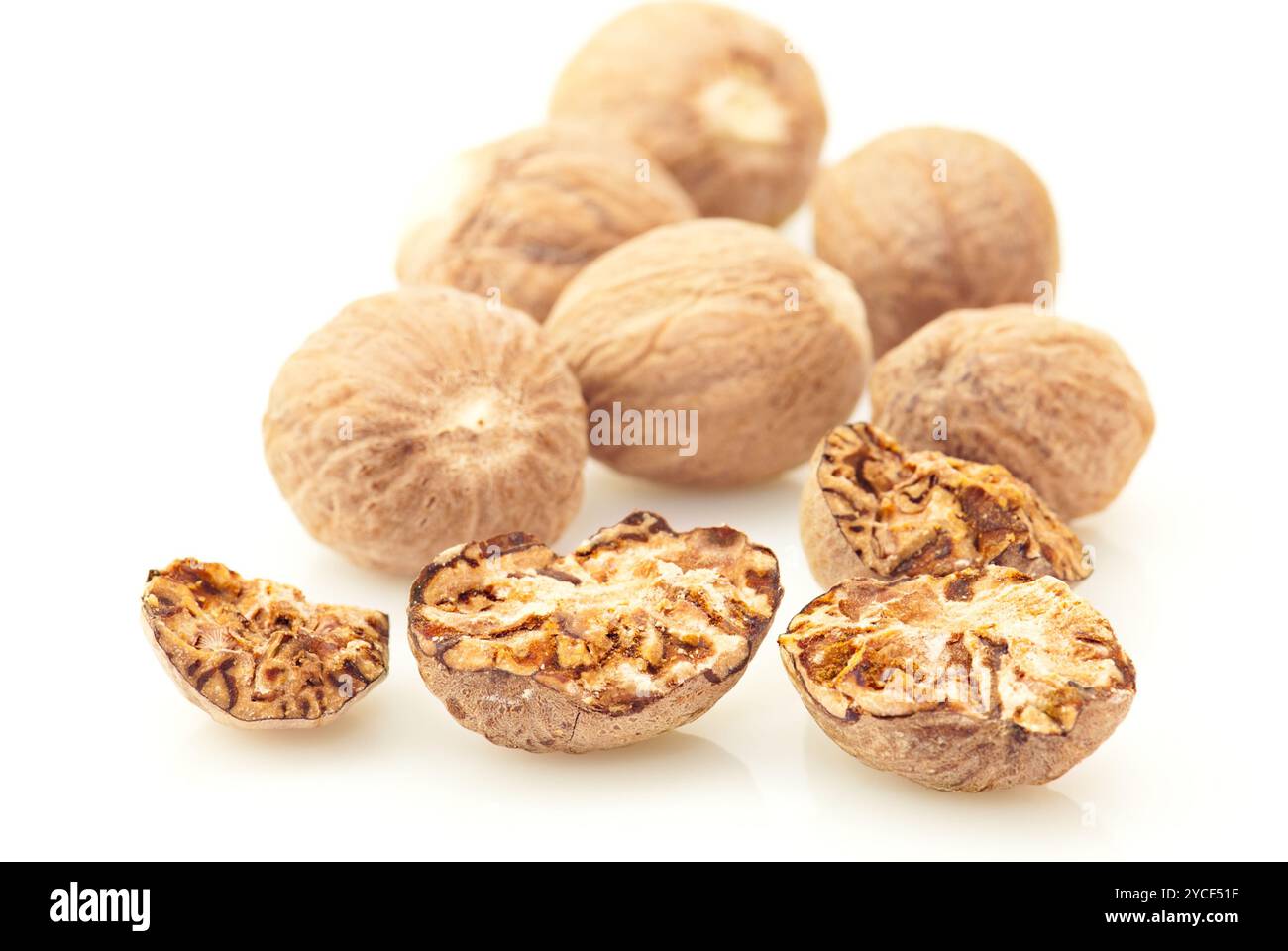 Nutmeg spice over white background Stock Photo - Alamy